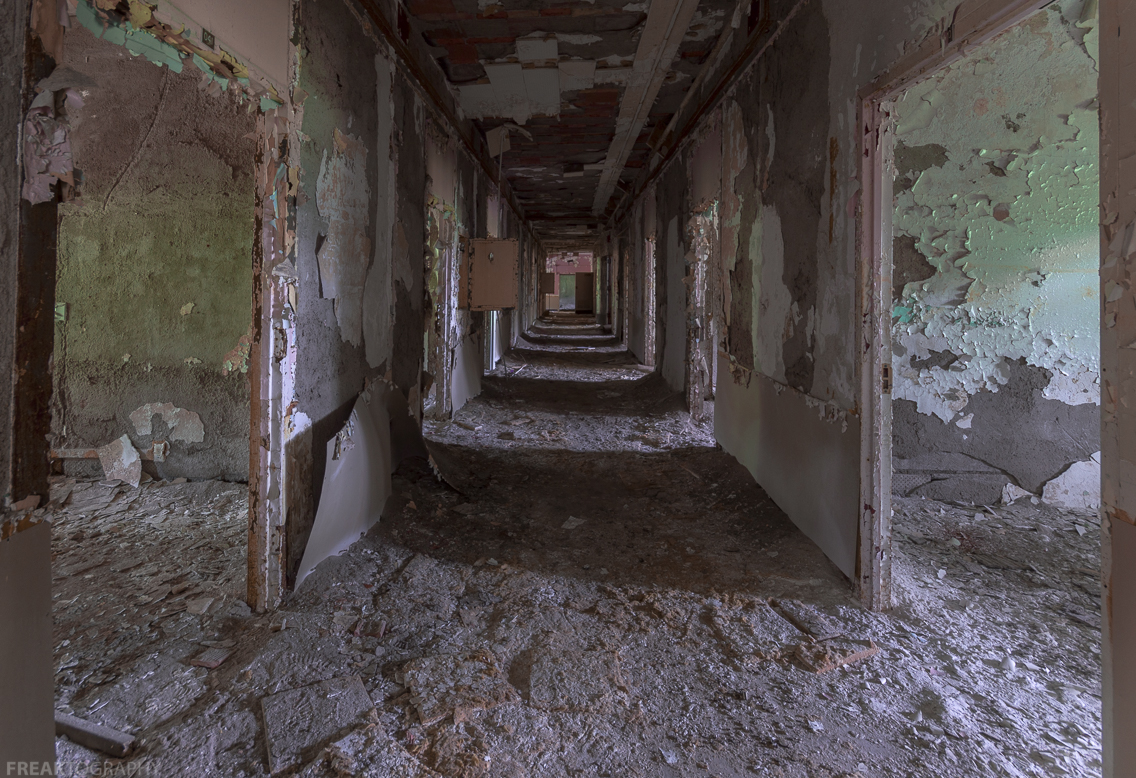 Crumbled ceiling tiles now cover the floor along this hallway in the ...